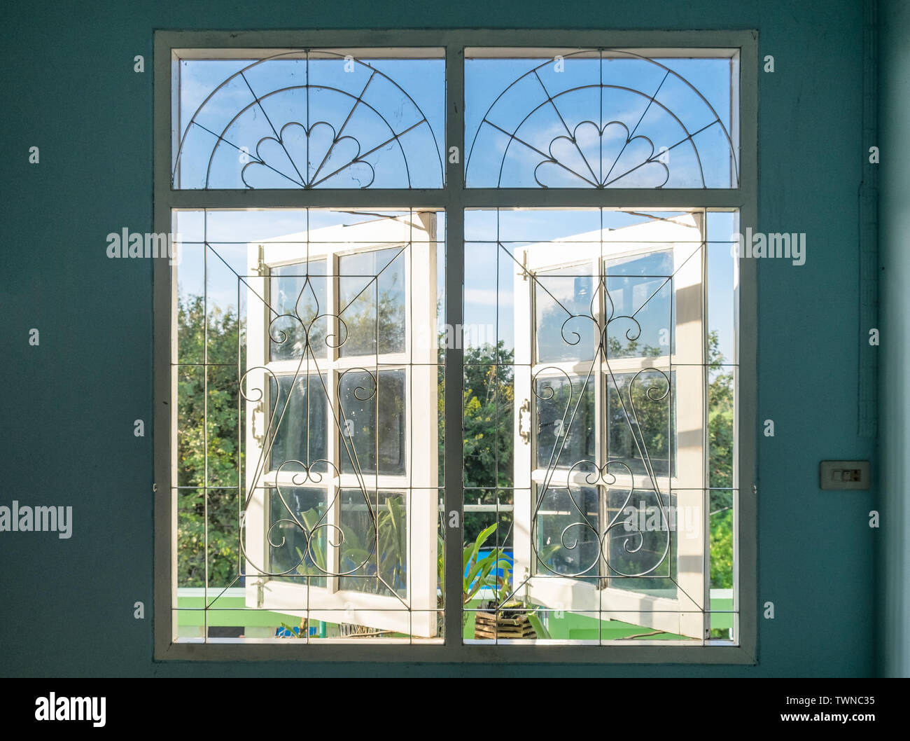 White windows with iron bar open to natural Stock Photo - Alamy
