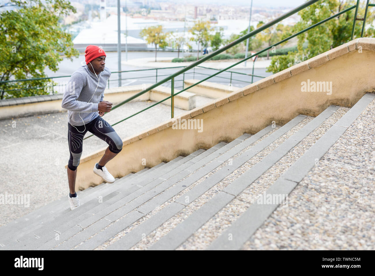 Black man running upstairs outdoors in urban background Stock Photo - Alamy