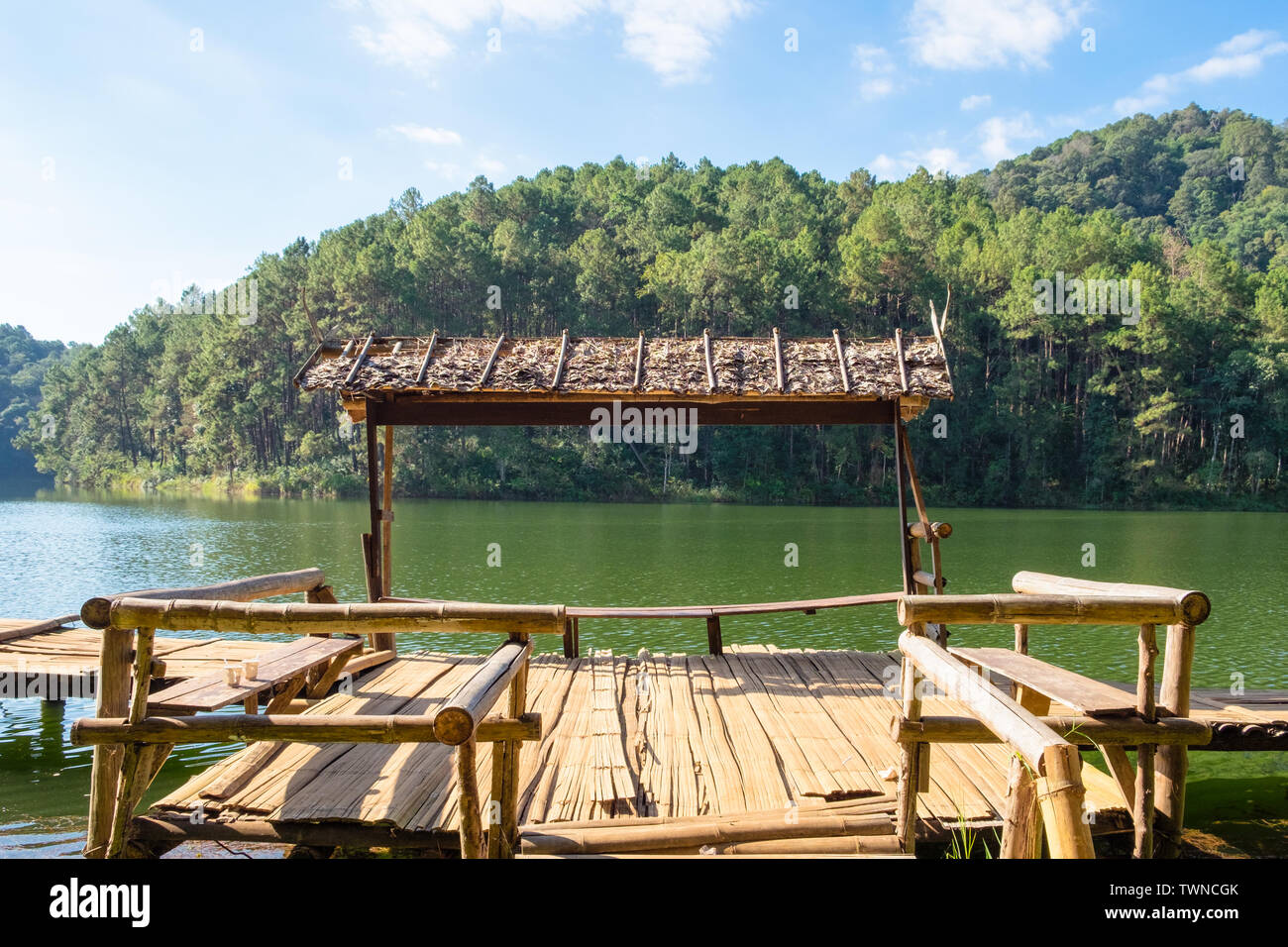 Bamboo cottage floating on rim reservoir in sunny Stock Photo - Alamy