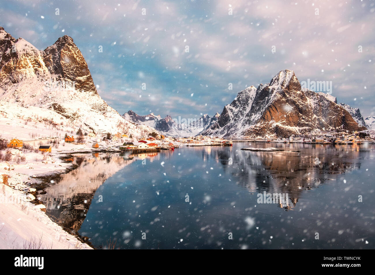 Scandinavian village in snowy valley on coastline with snowfall in ...