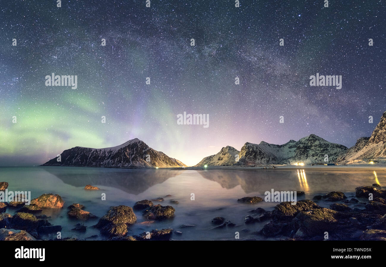 Panorama of Aurora borealis with Milky way galaxy over snow mountain in ...