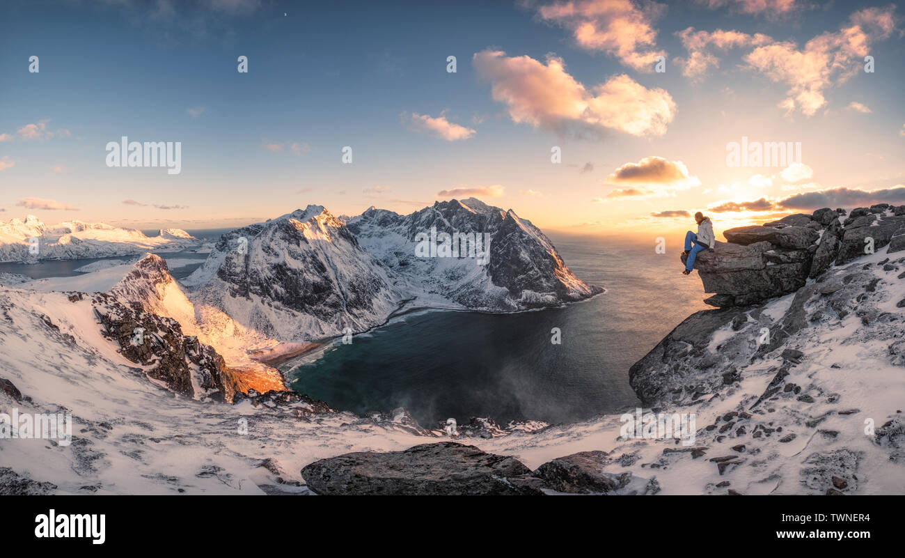 Panorama of Mountaineer sitting on rock on peak mountain of arctic ...