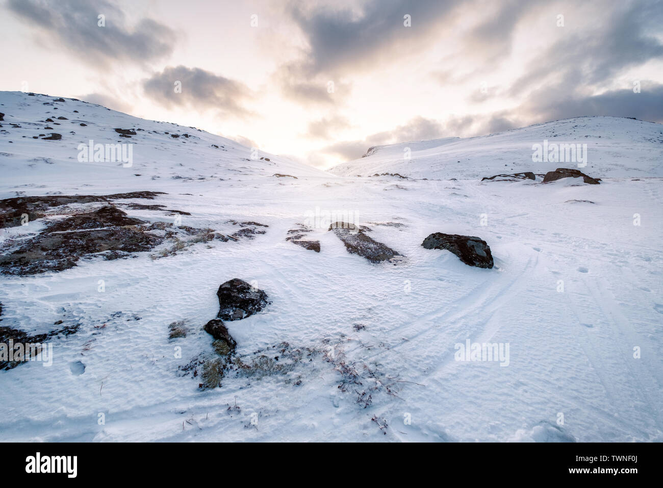 Snowy landscape with sunlight in valley on peak Stock Photo - Alamy