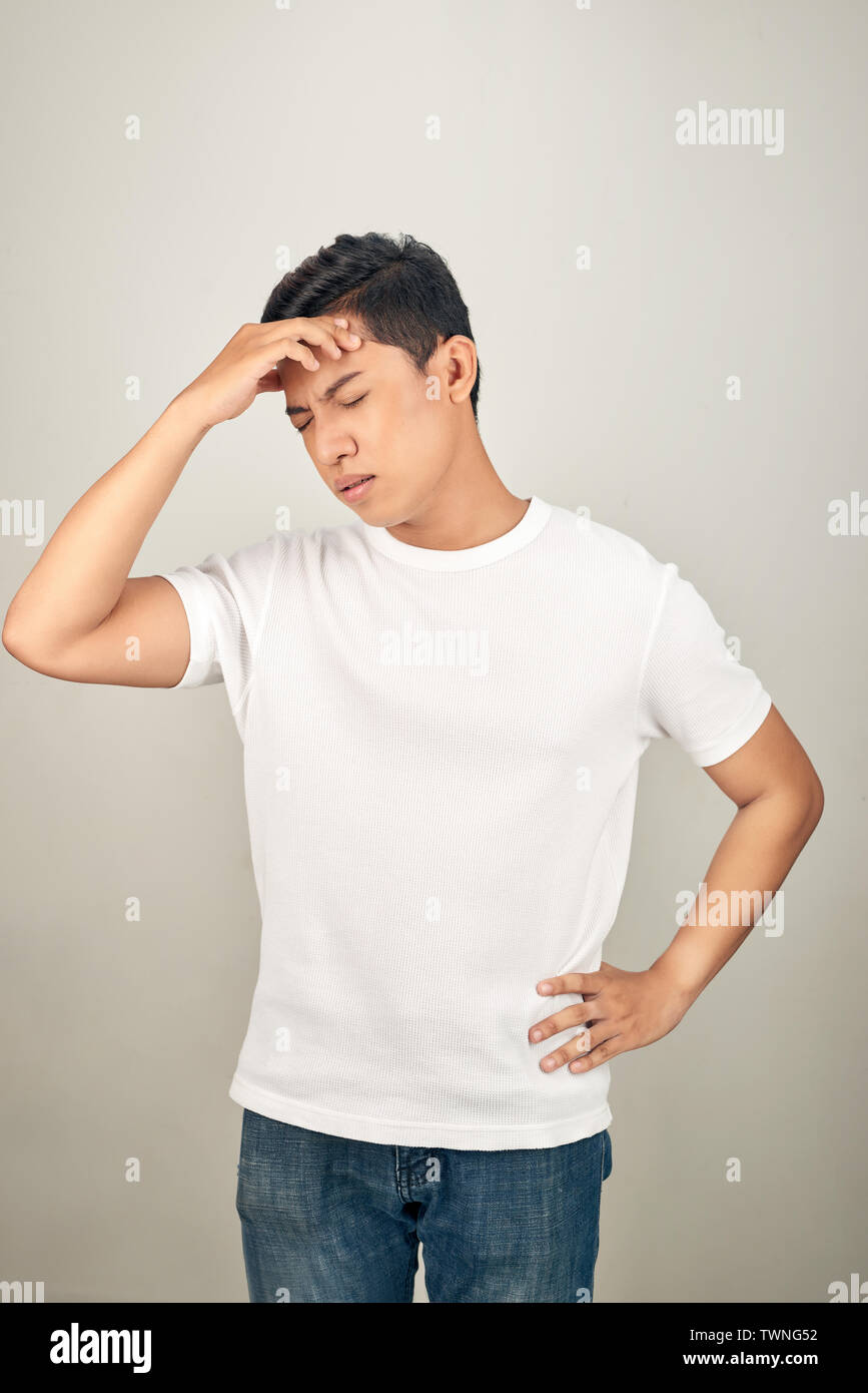 Good-looking asian man showing how much his head hurts, experiencing ...