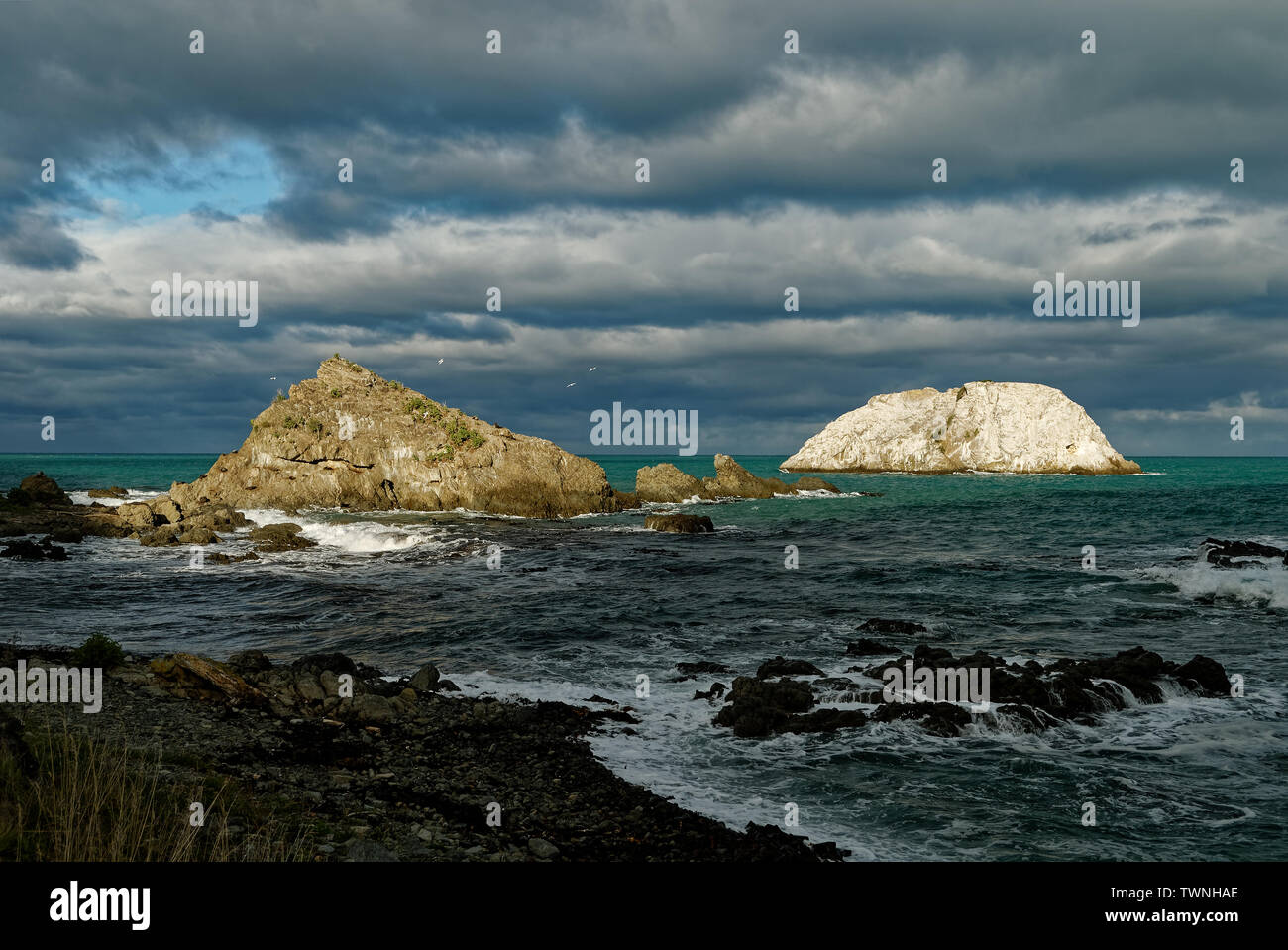 The sun lights a small island in the sea Stock Photo - Alamy