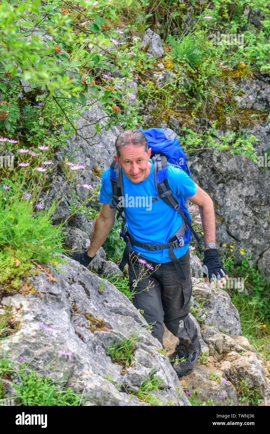 Good-humoured young people hiking on rocky trail in franconian hills ...