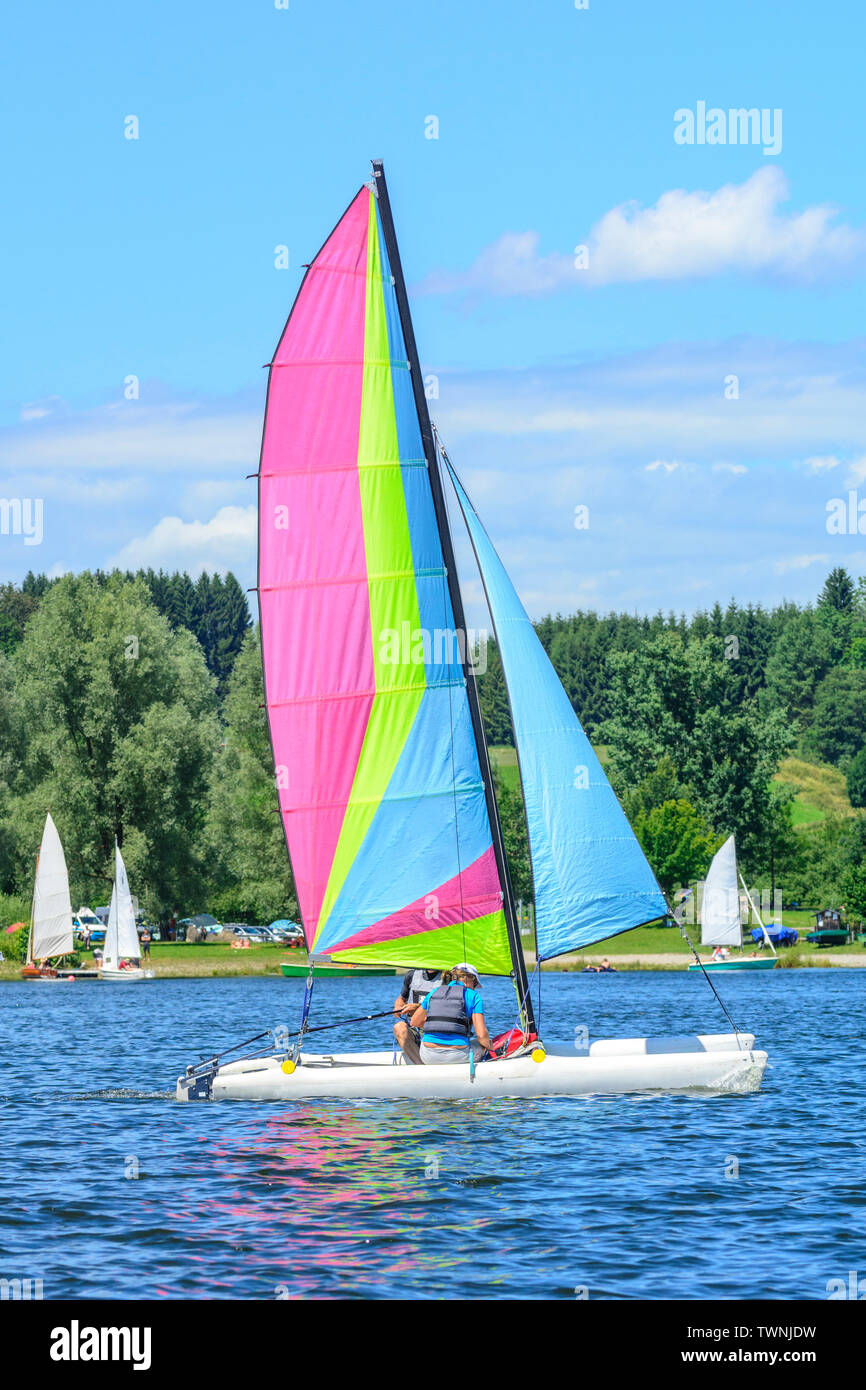Catamaran sailing on inland lake in summertime Stock Photo - Alamy