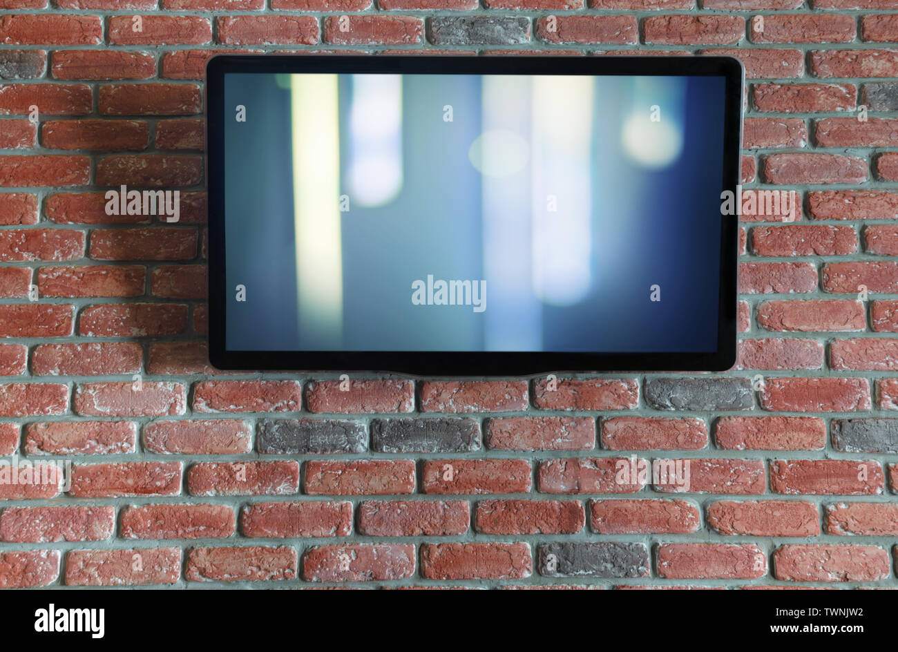 TV on a red brick wall with an abstract splash on the screen Stock ...