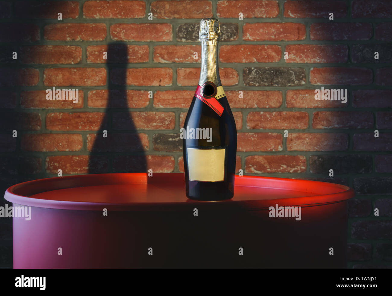 Bottle of champagne on a big red barrel Stock Photo - Alamy