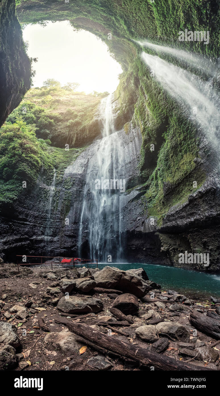 Majestic Madakaripura waterfall flowing in rocky valley at East Java ...