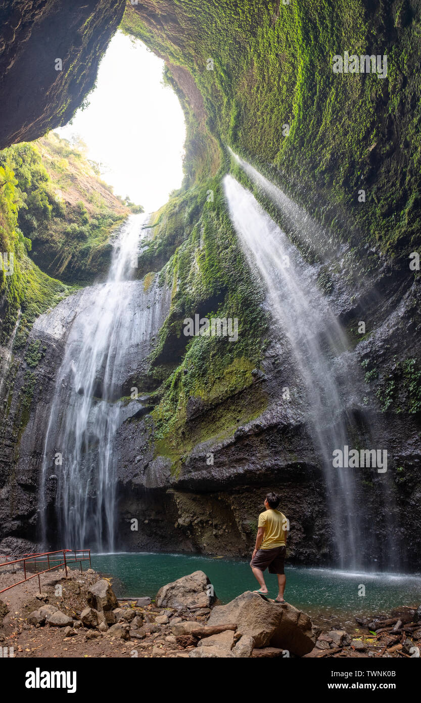 Majestic waterfall flowing on rocky cliff in tropical rainforest ...