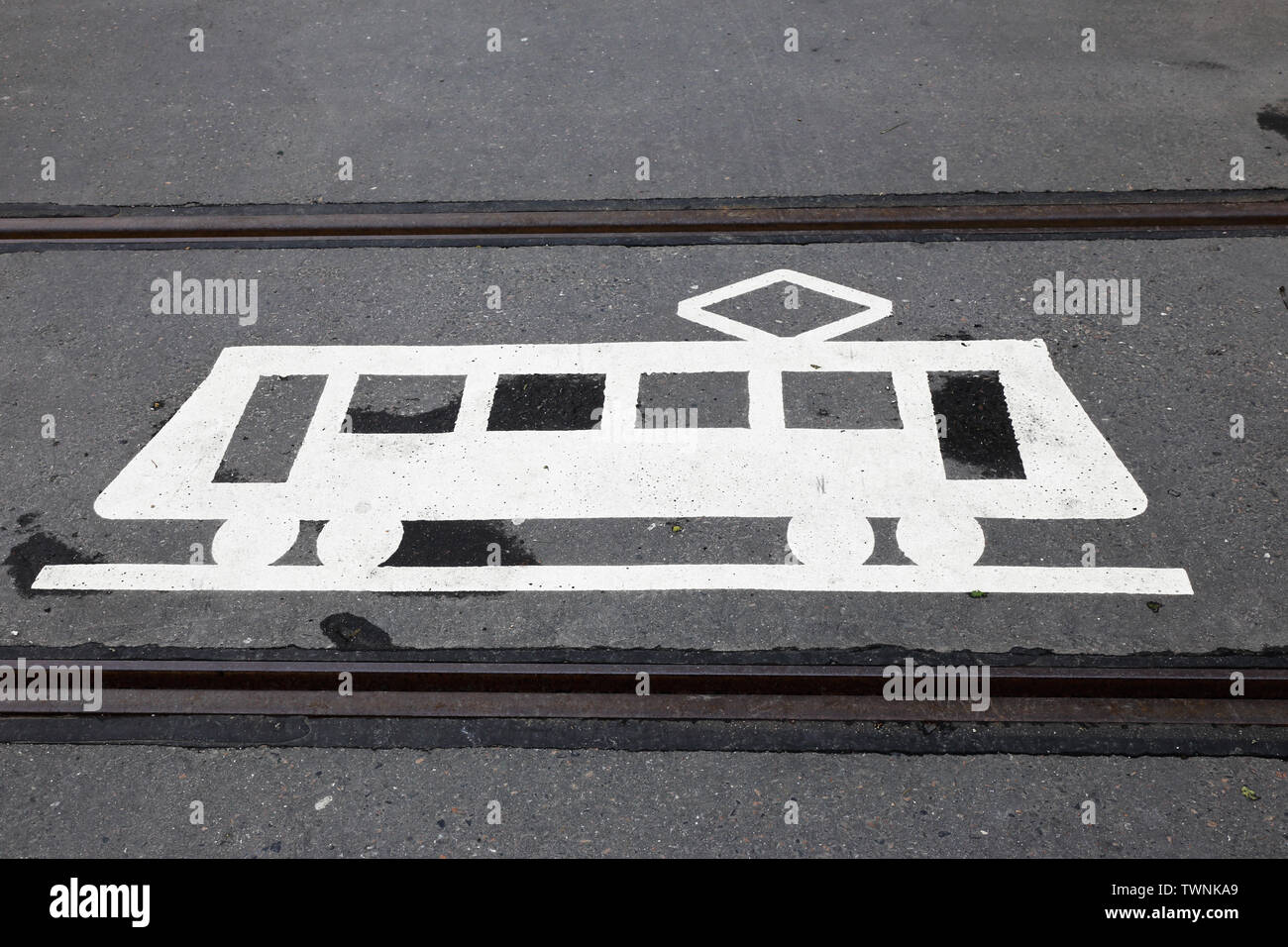 A road marking tram warning sign painted on the tramway Stock Photo - Alamy