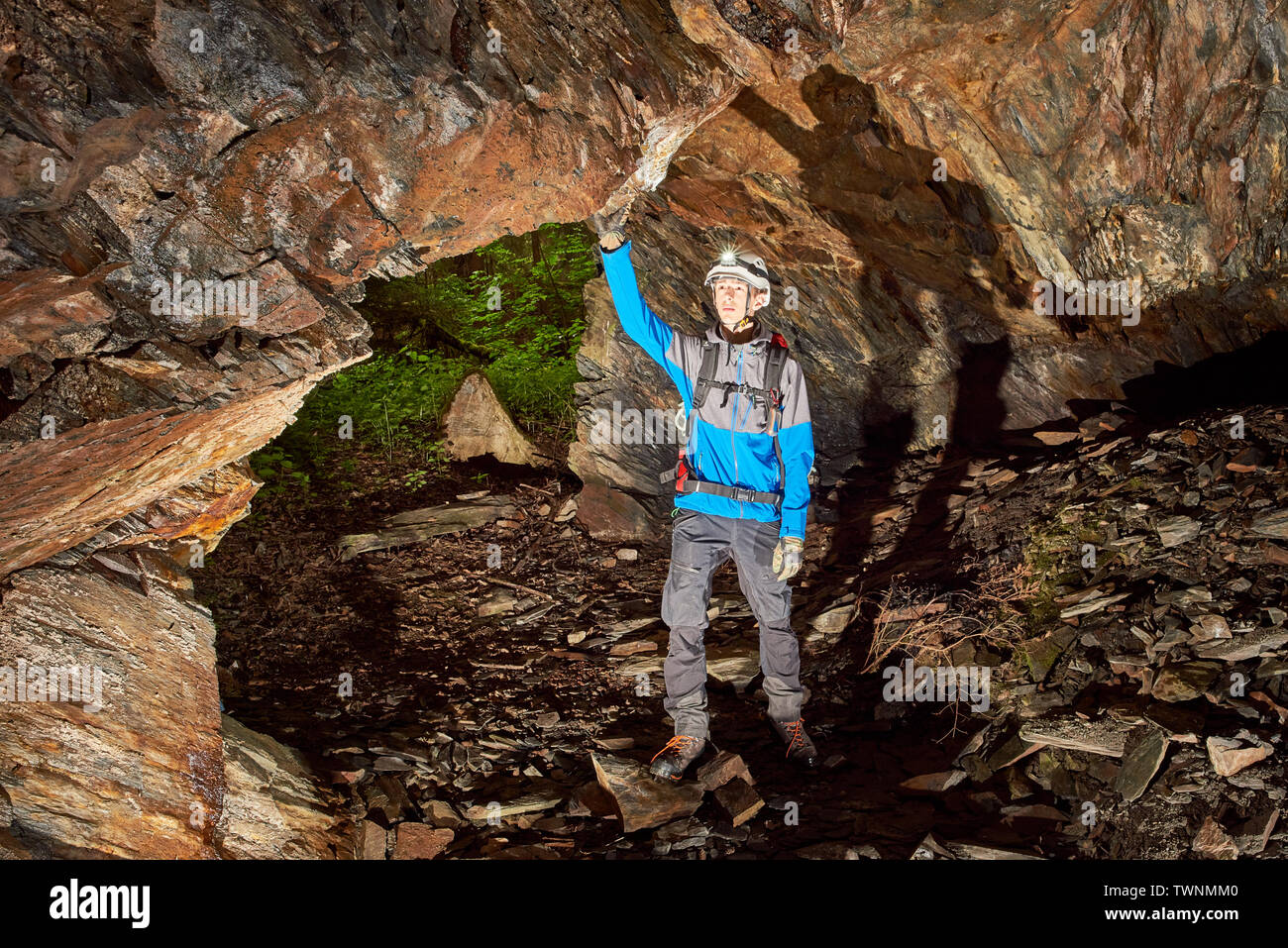 Young speleologist exploring a cave Stock Photo - Alamy