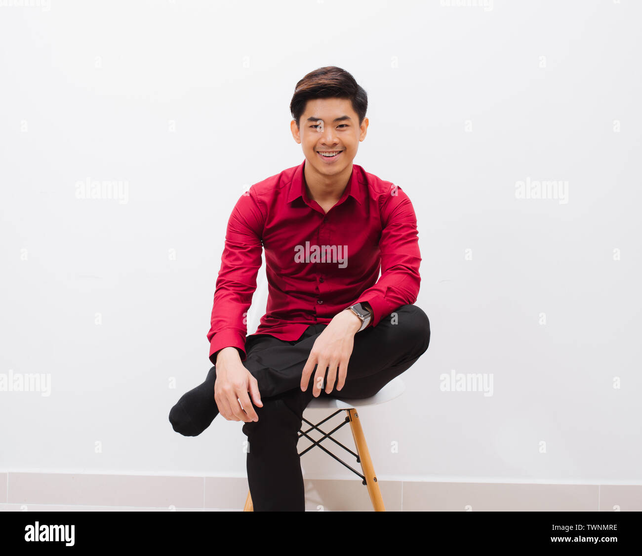 Feeling comfortable anywhere. Handsome young man looking at camera with ...