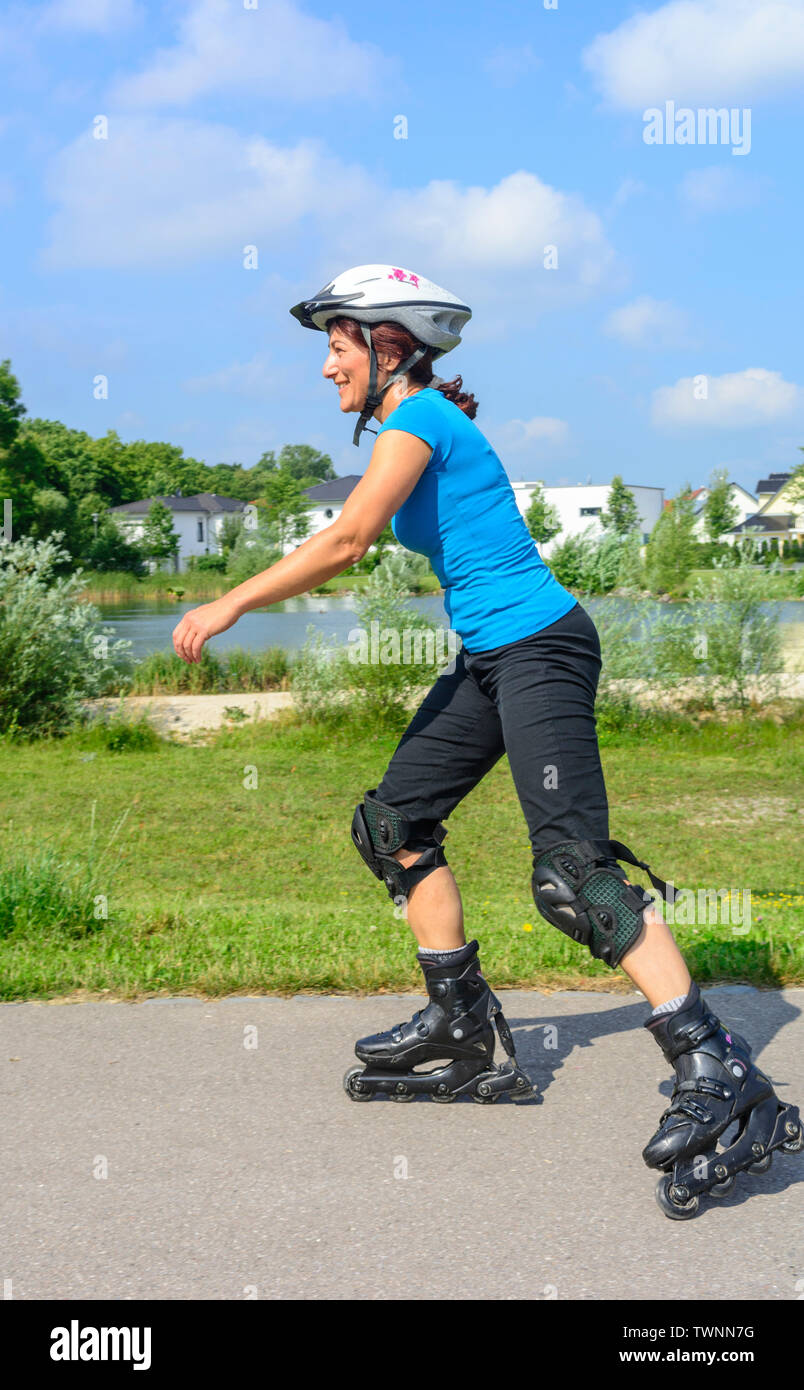 Woman having fun while doing a tour with inline skates Stock Photo - Alamy