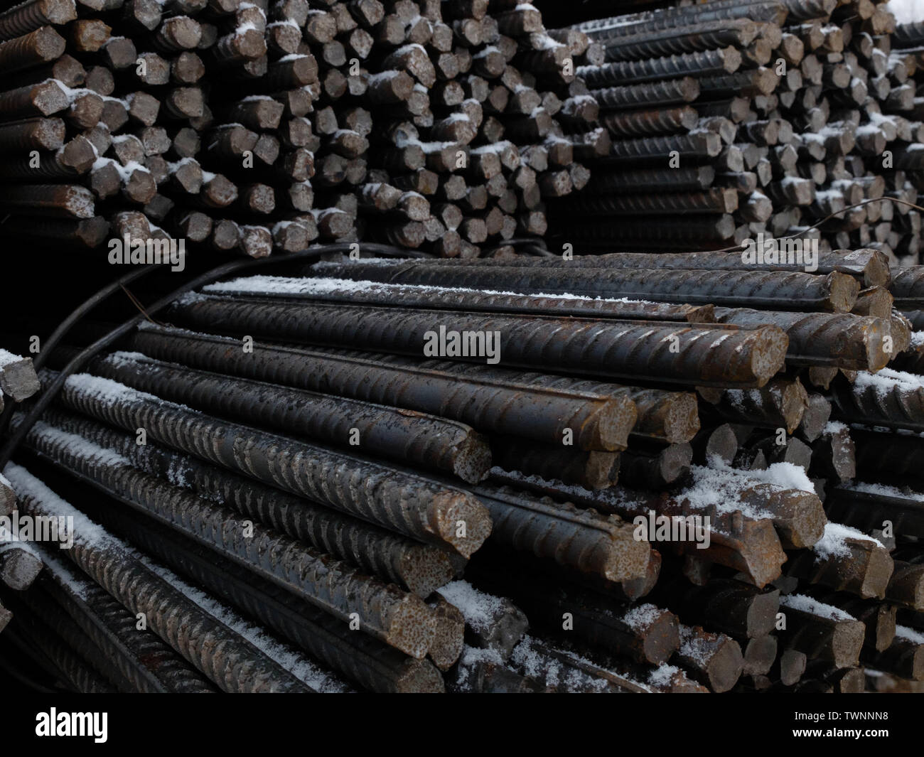 Steel snow covered reinforcement bars at the outdoor warehouse ...
