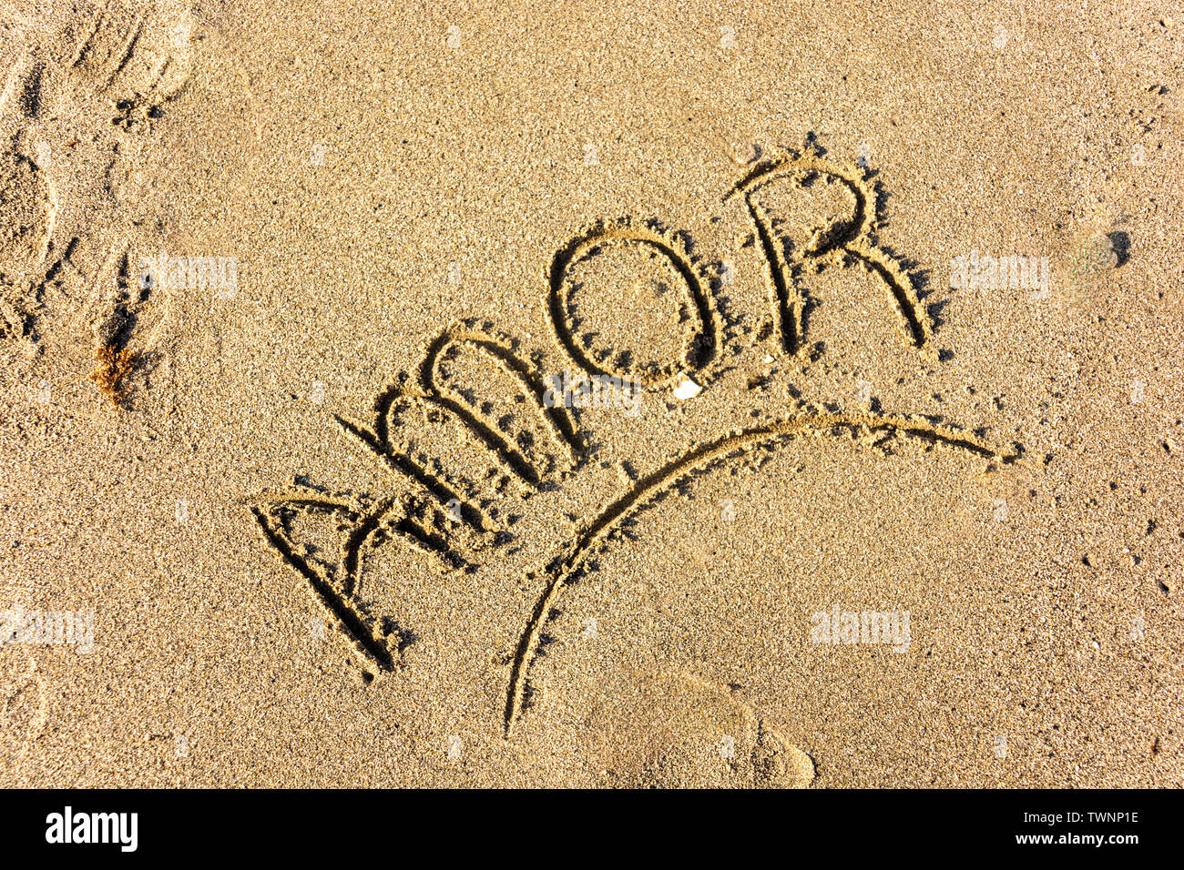 Amor (love) word writen in the sea sand Stock Photo - Alamy