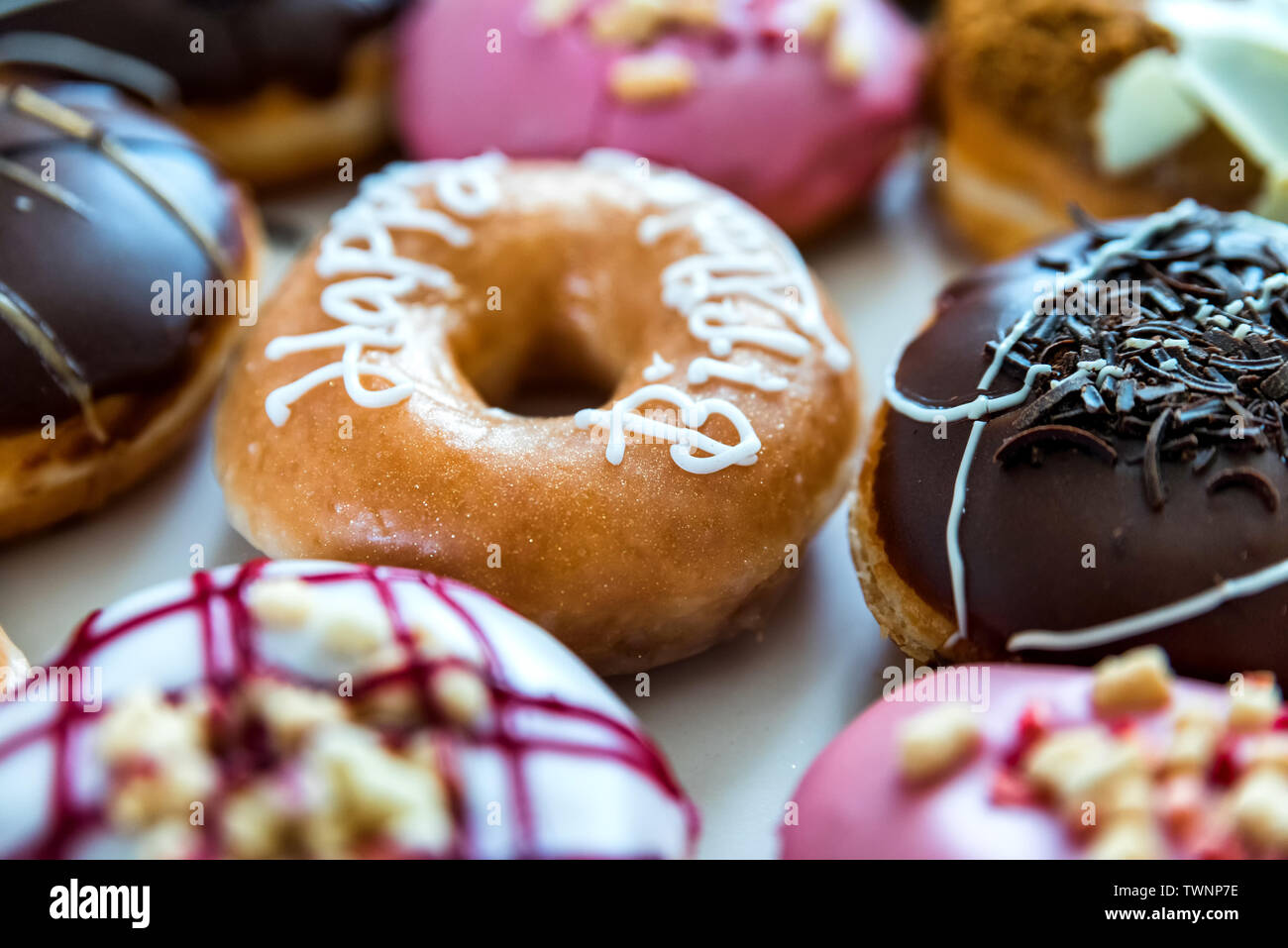 happy birthday multicoloured donuts inside white box Stock Photo - Alamy