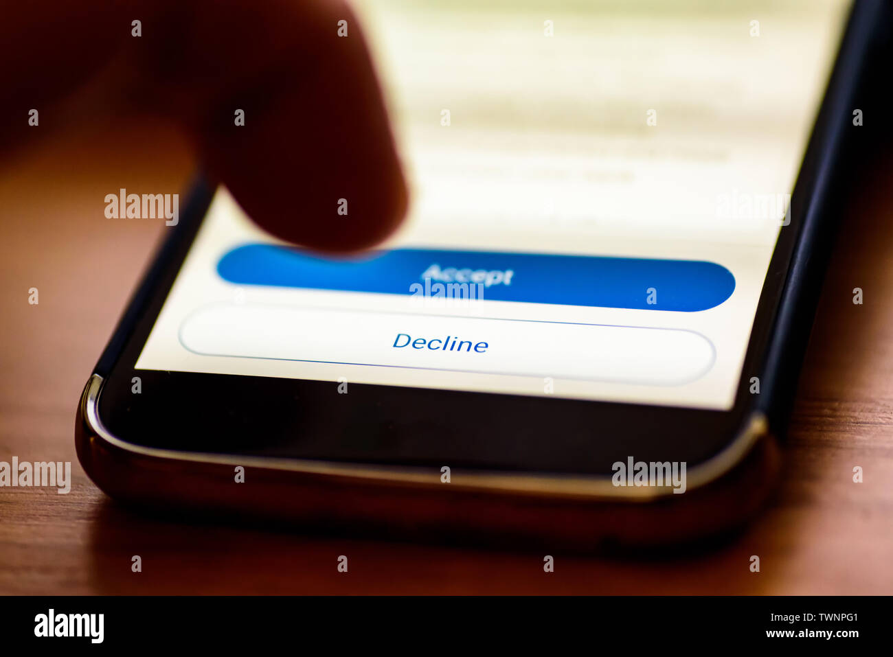 Decline button on smartphone screen closeup with human finger pointing ...