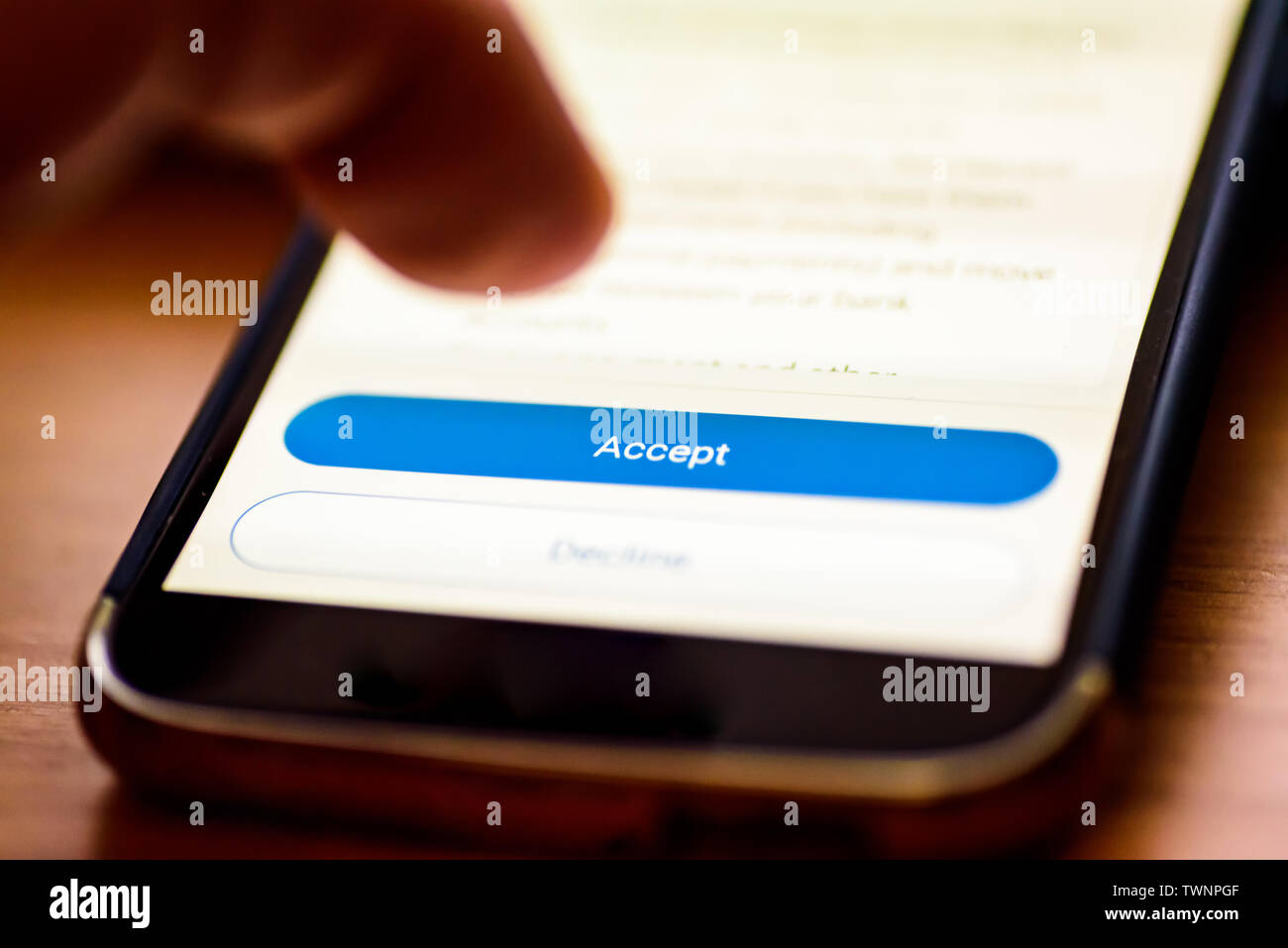 Accept button on smartphone screen closeup with human finger pointing ...