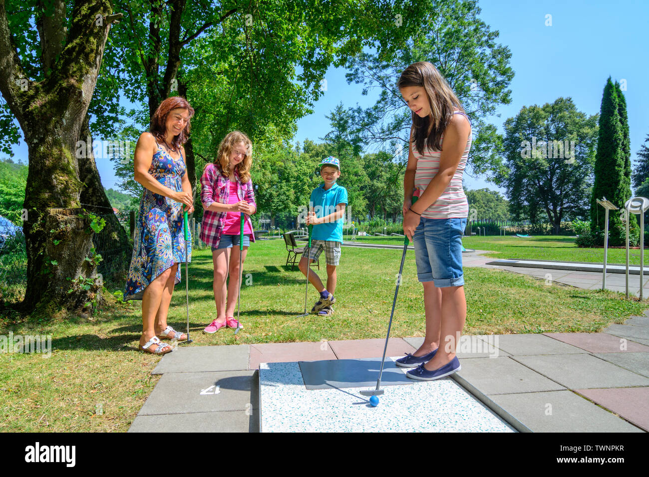 Funny afternoon with the Kids on a minigolf course Stock Photo - Alamy