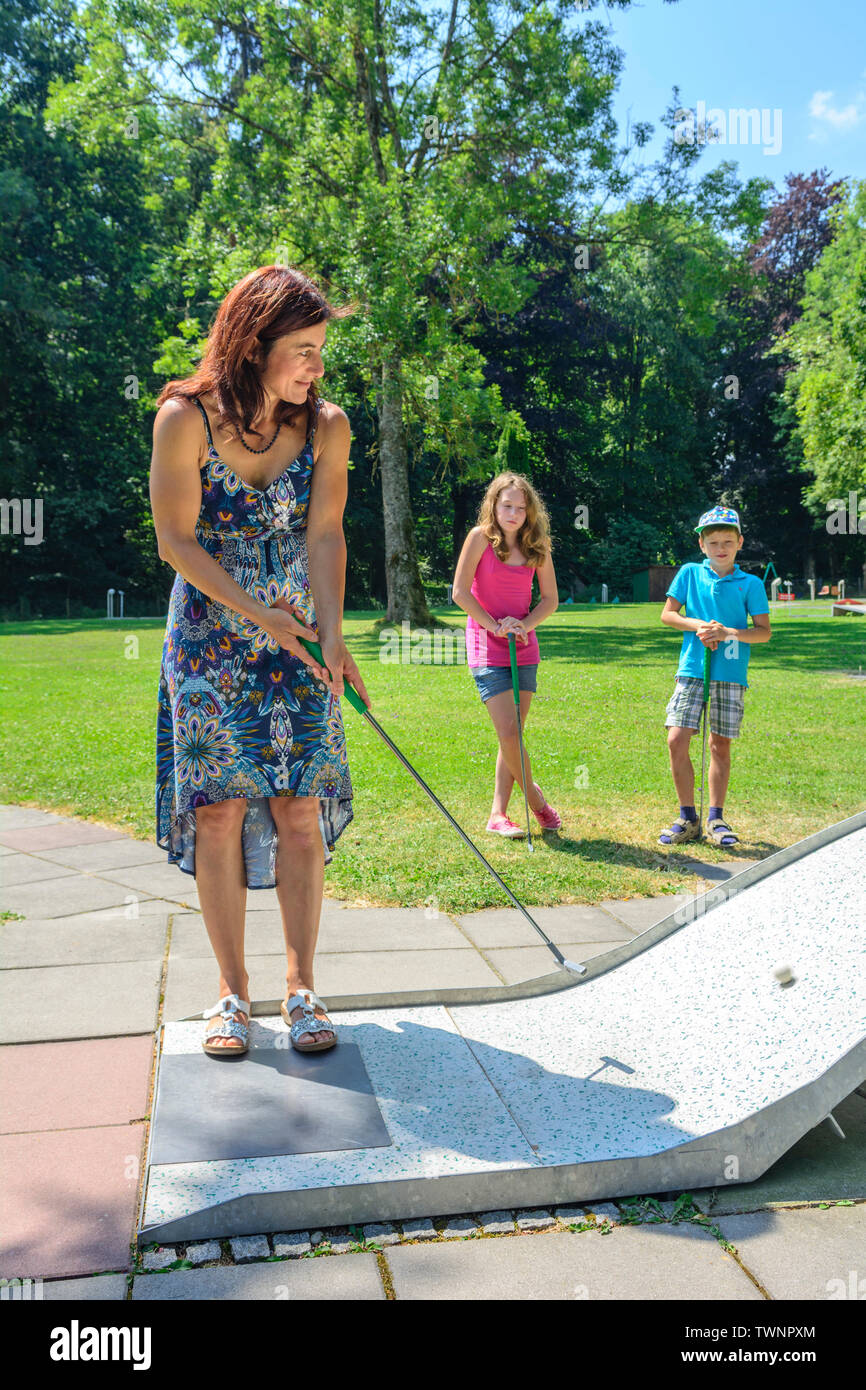 Funny afternoon with the Kids on a minigolf course Stock Photo - Alamy