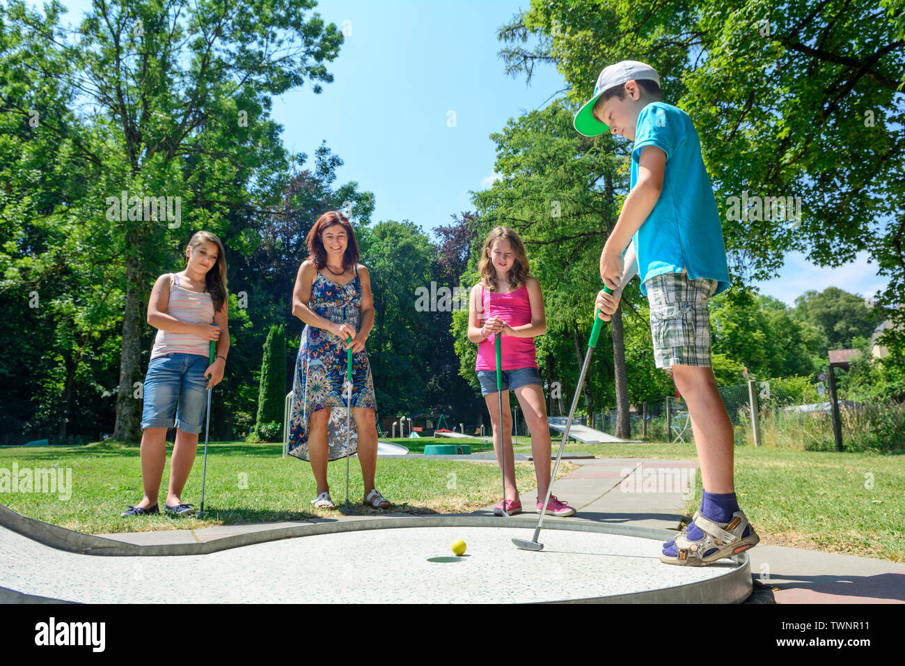 Funny afternoon with the Kids on a minigolf course Stock Photo - Alamy
