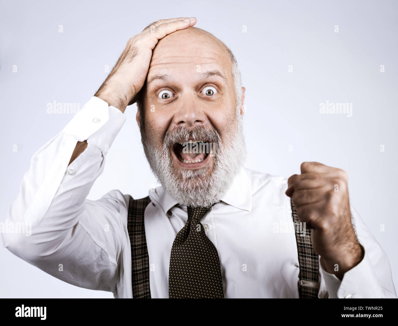 Cheerful successful senior businessman winning and celebrating his ...