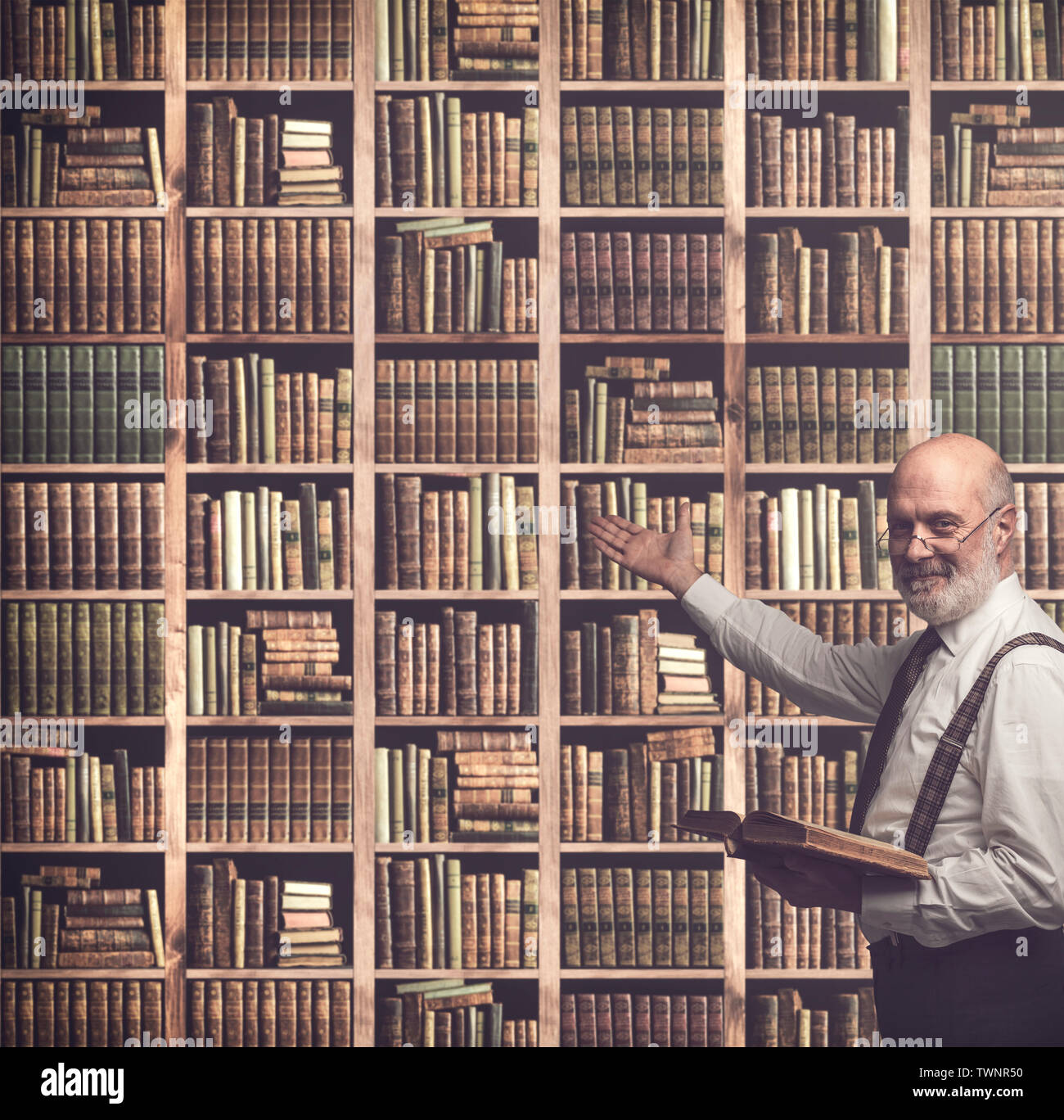 Academic professor smiling and showing books in the library, knowledge ...