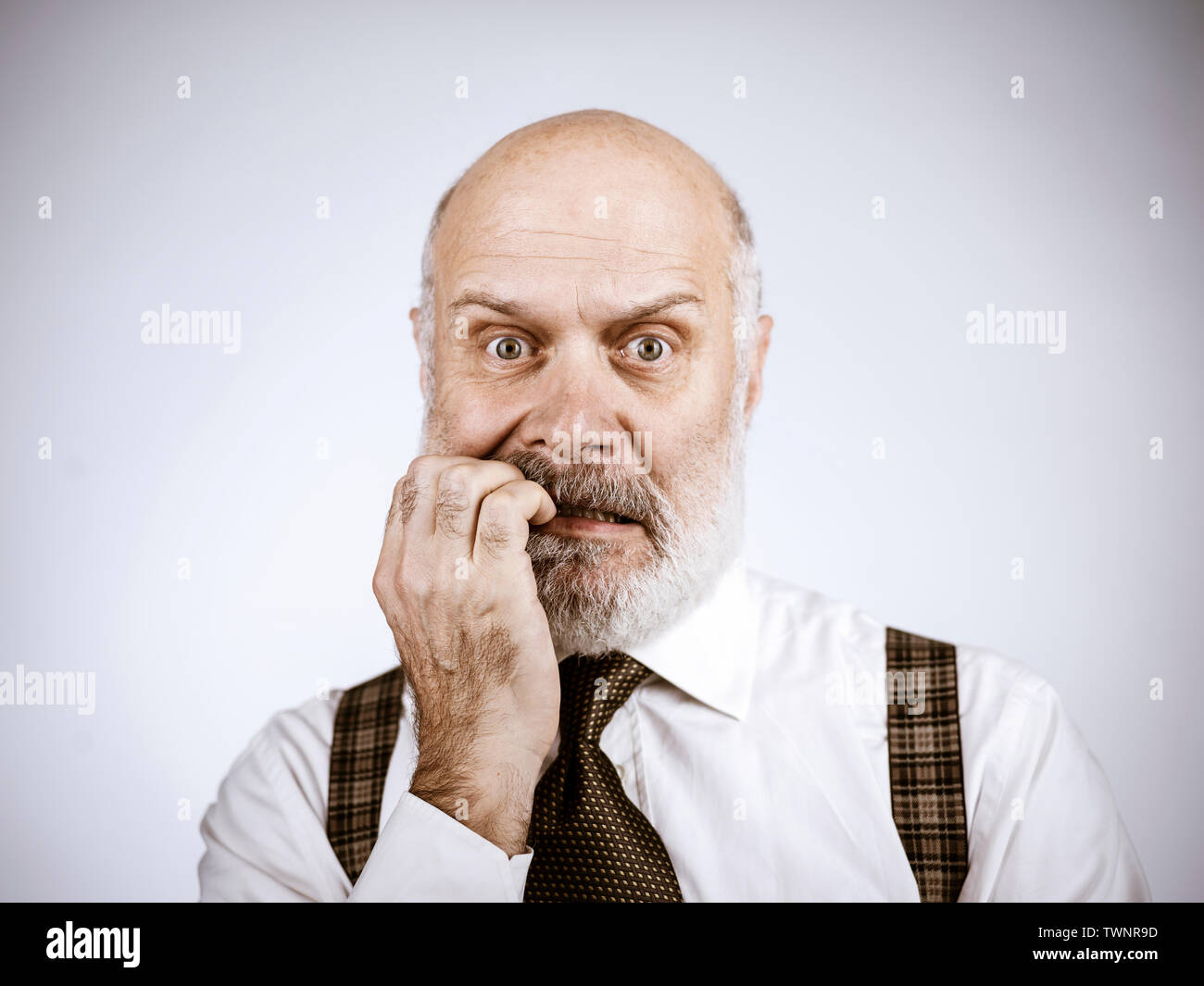 Nervous anxious senior business man biting his nails, he is scared and ...