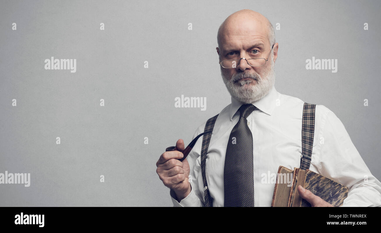 Confident serious academic professor posing with old books: traditional ...