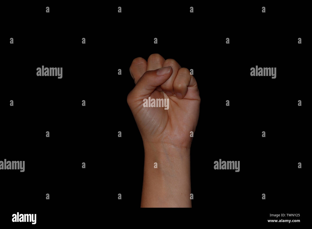 Isolated Fist Of Woman On Black Background With Palm Facing Towards Camera Showing Concepts Of