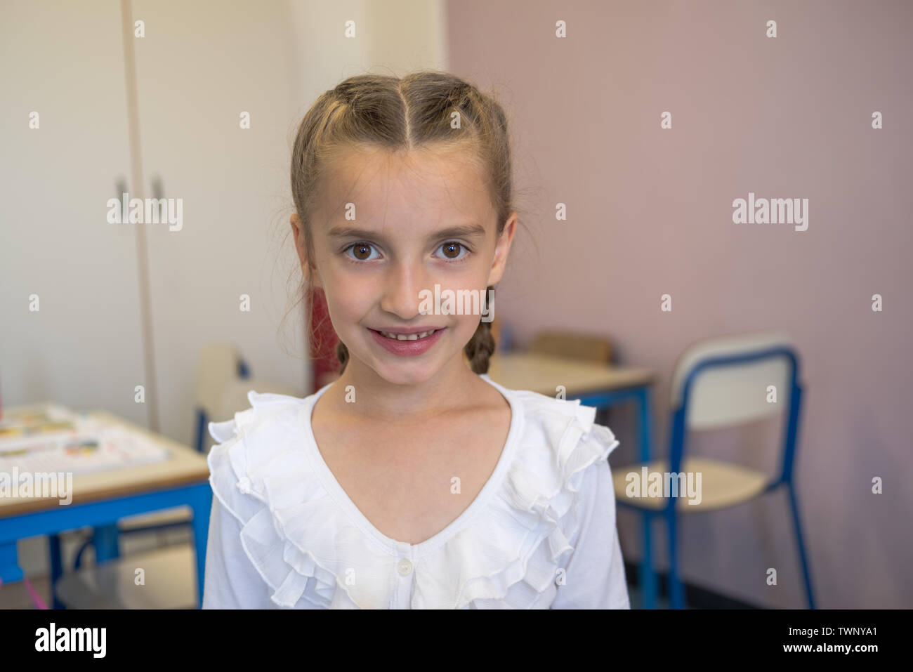 Pretty elementary school girl posing at camera Stock Photo - Alamy