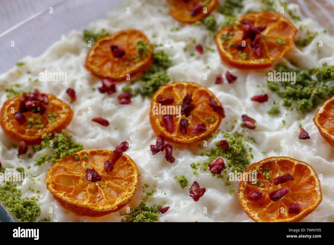 traditional Turkish dessert: gullac; with peanuts, dried orange slices ...