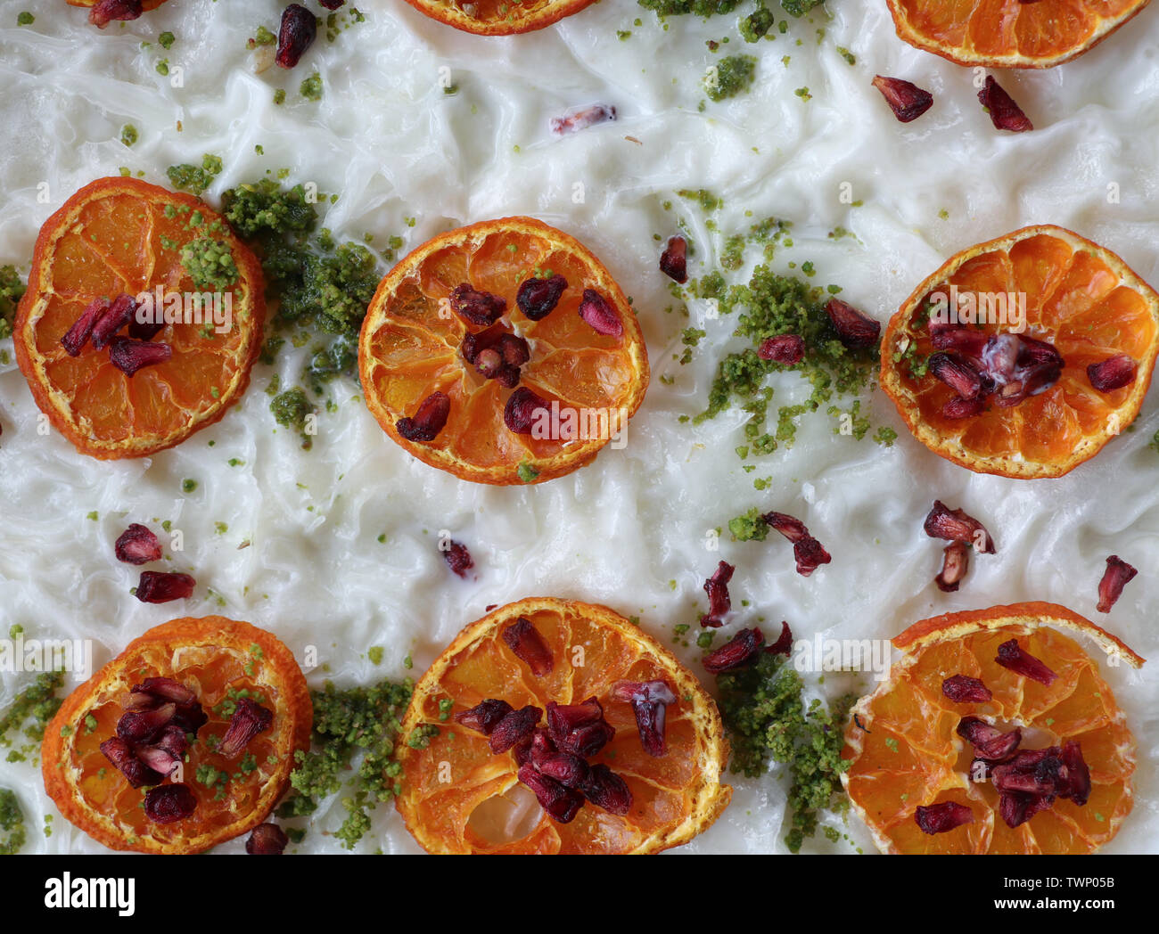 traditional Turkish dessert: gullac; with peanuts, dried orange slices ...