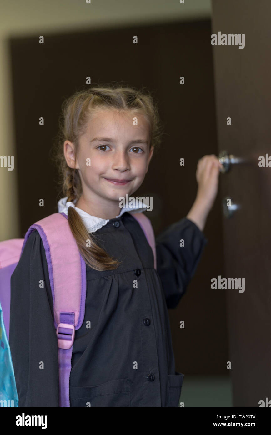 Elementary school student in uniform enters the classroom Stock Photo ...