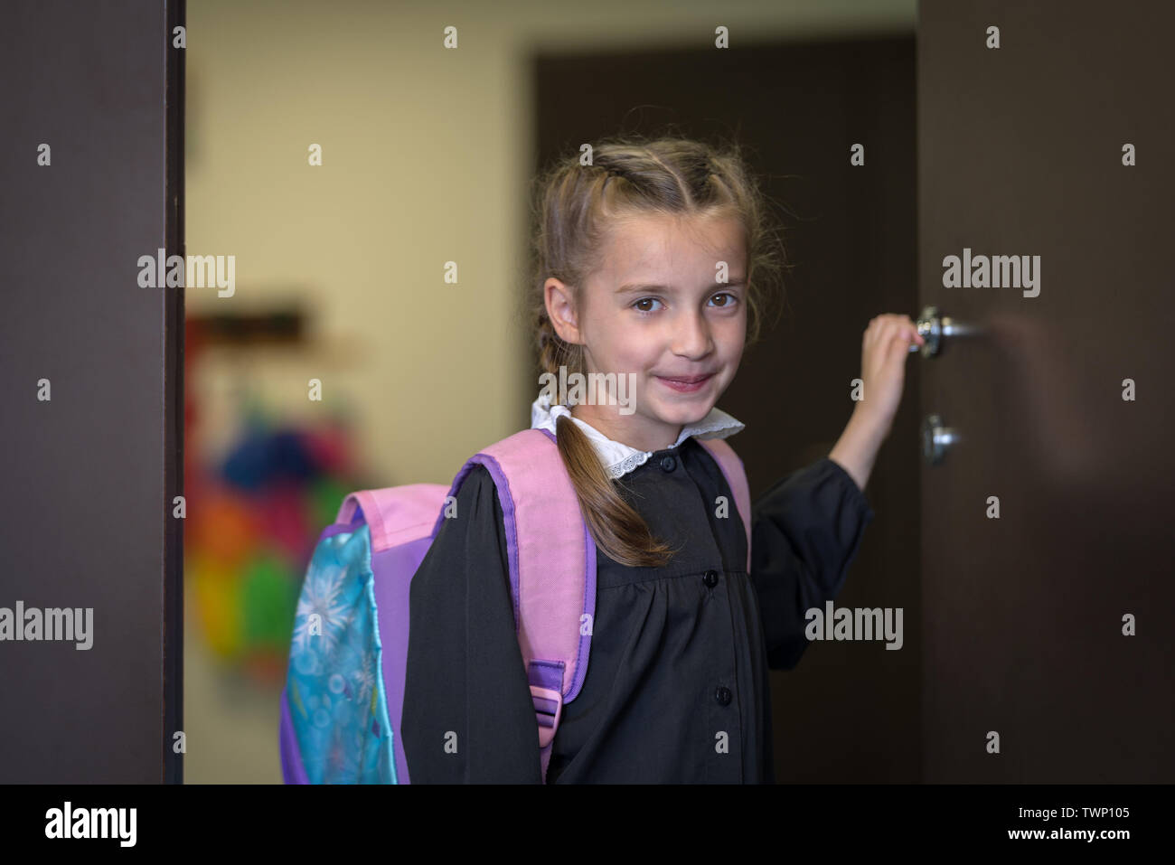 Elementary school student in uniform enters the classroom Stock Photo ...