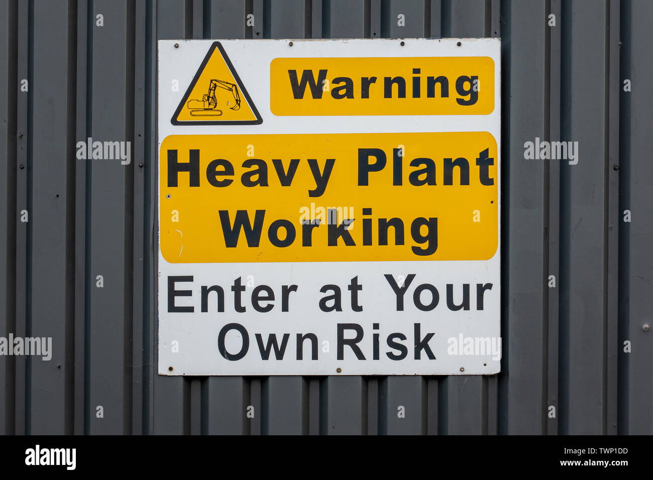 Warning heavy plant working enter at your own risk sign on the side of ...