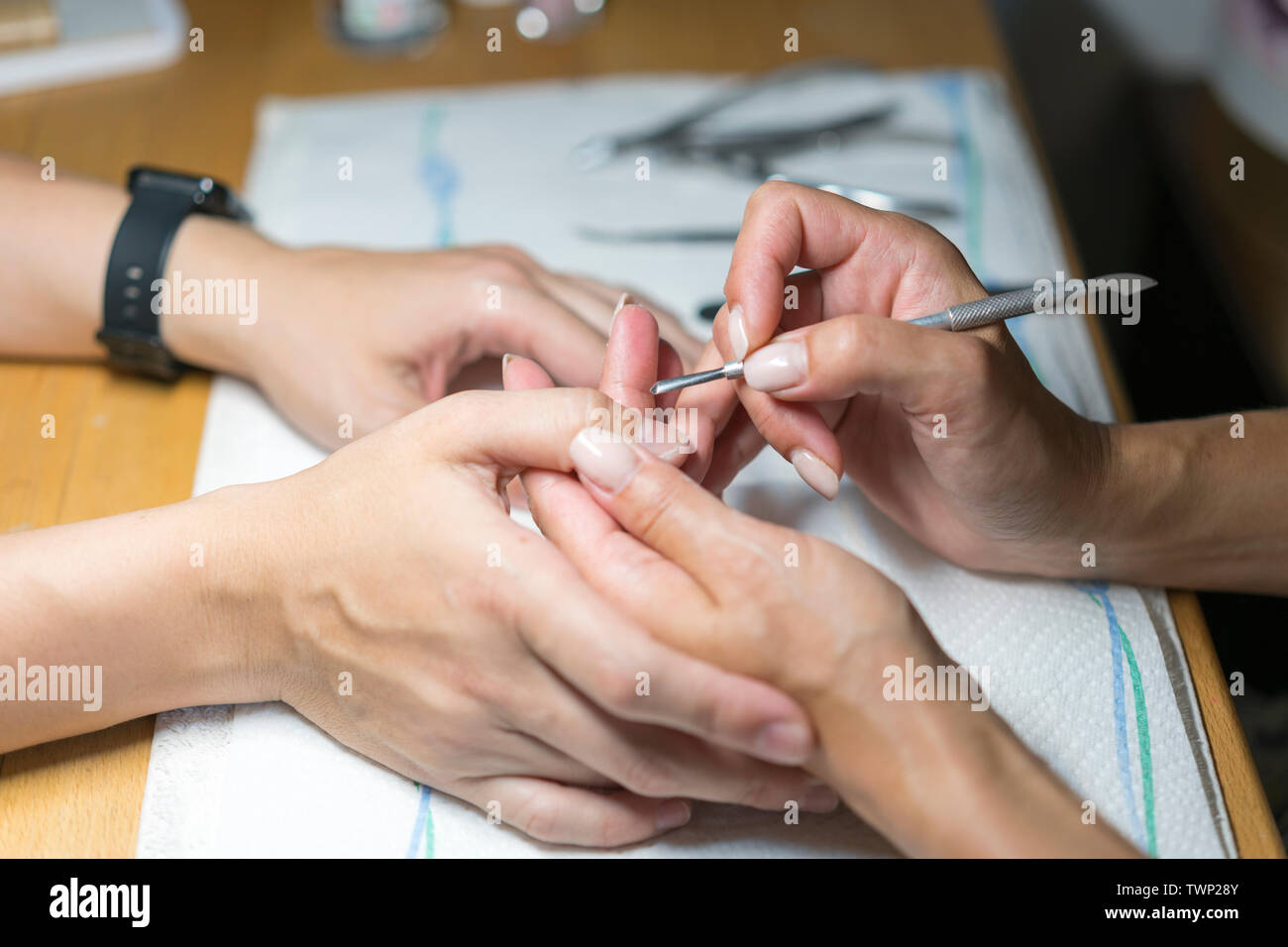 Close up woman hand while process of manicure in nail shop. Beautiful ...