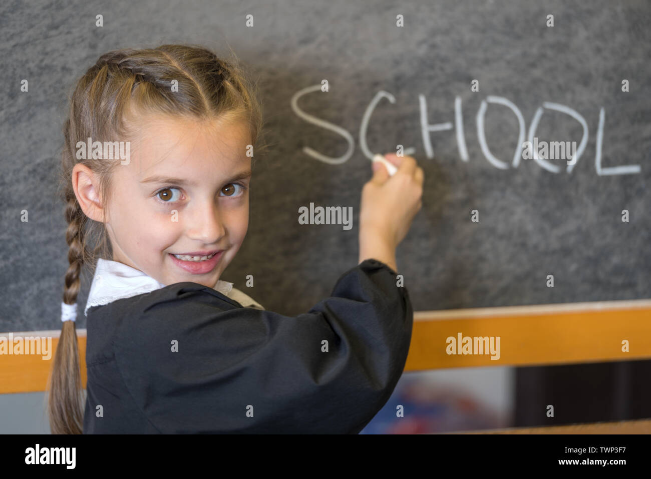 Elementary school student girl in uniform at the blackboard Stock Photo ...