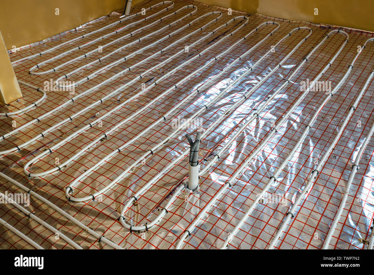 Close up on water floor heating system interior Stock Photo - Alamy
