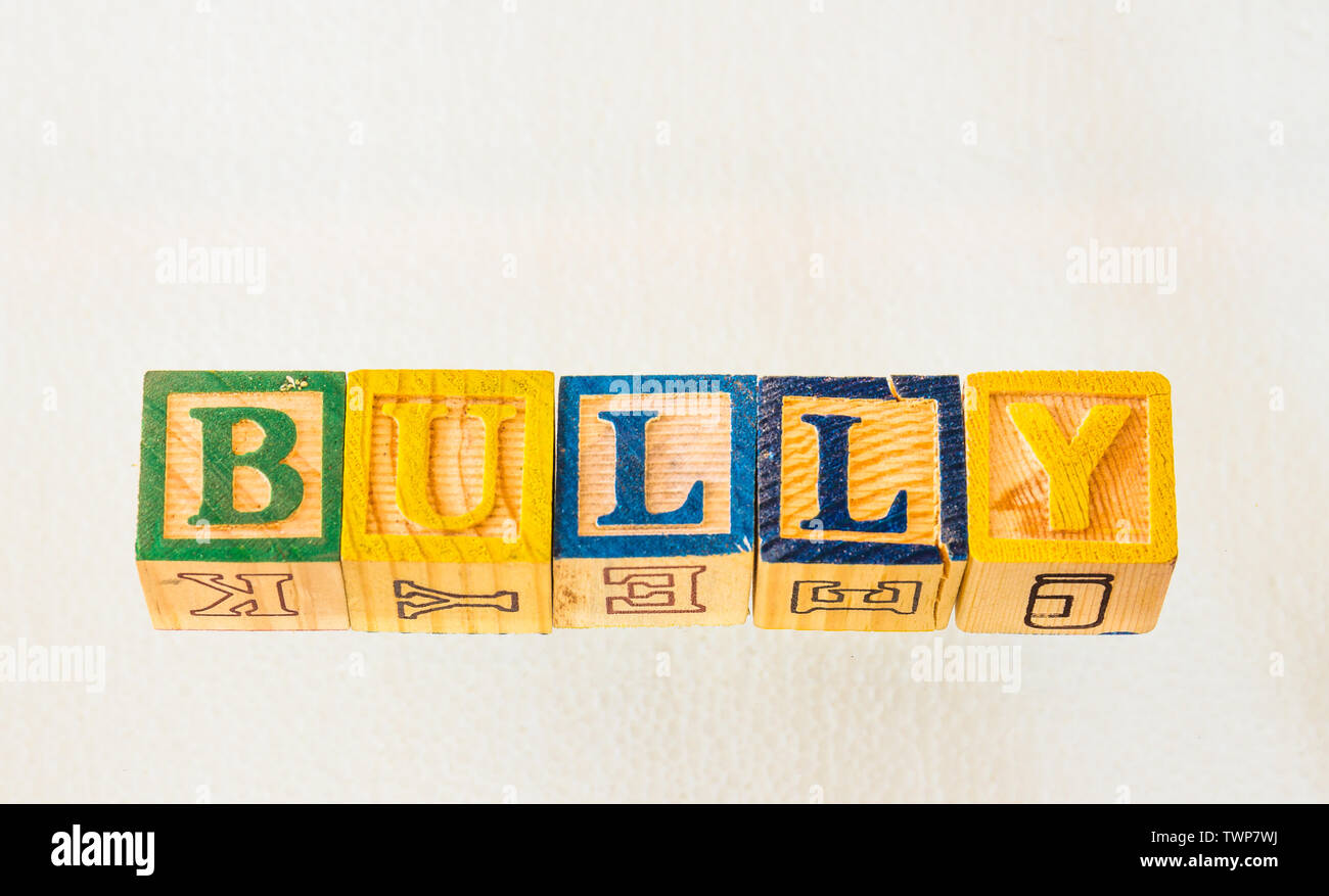 The term bully visually displayed using colorful wooden toy blocks on a ...
