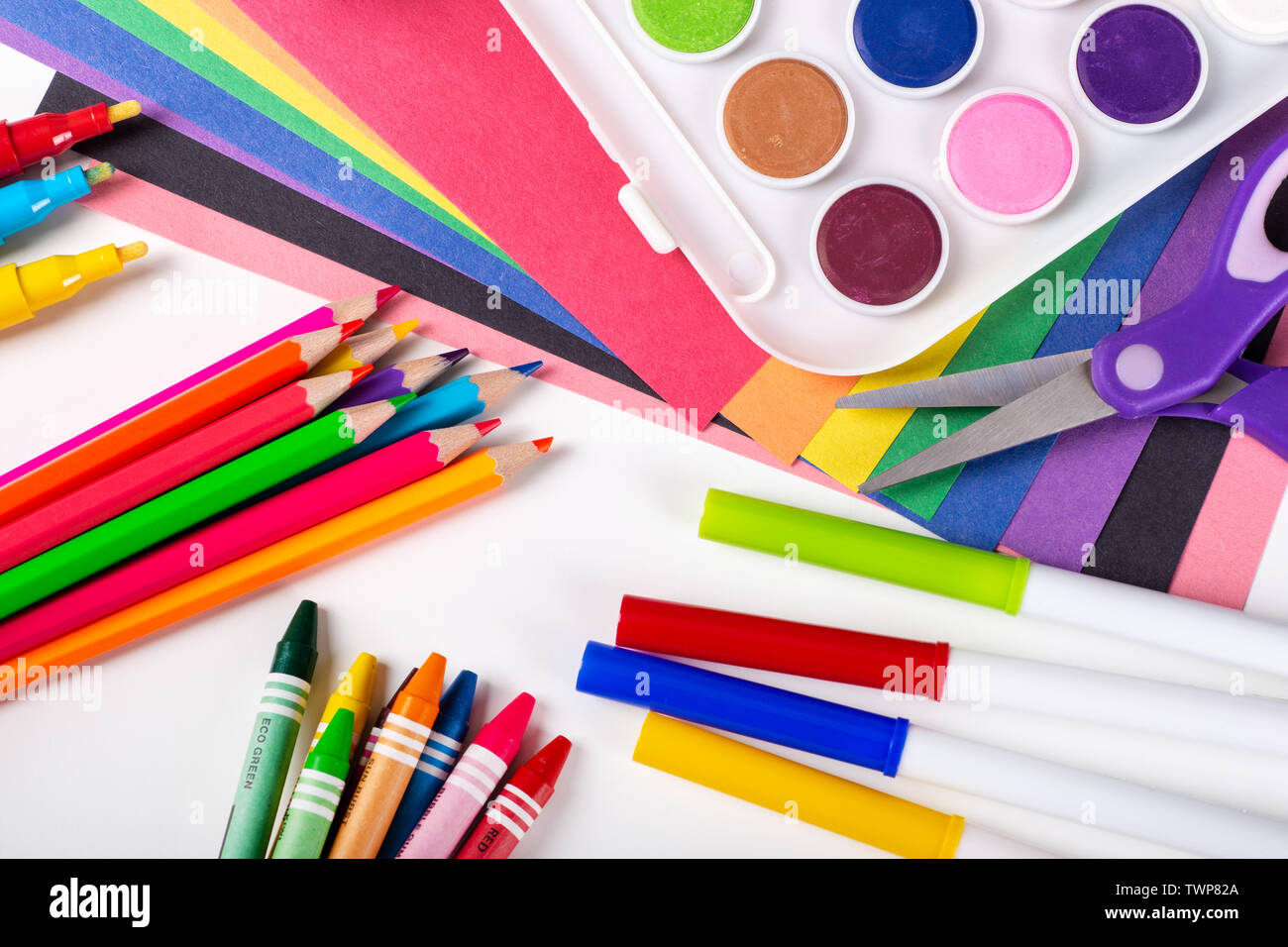 Overhead view of an assortment of school craft items on a white ...