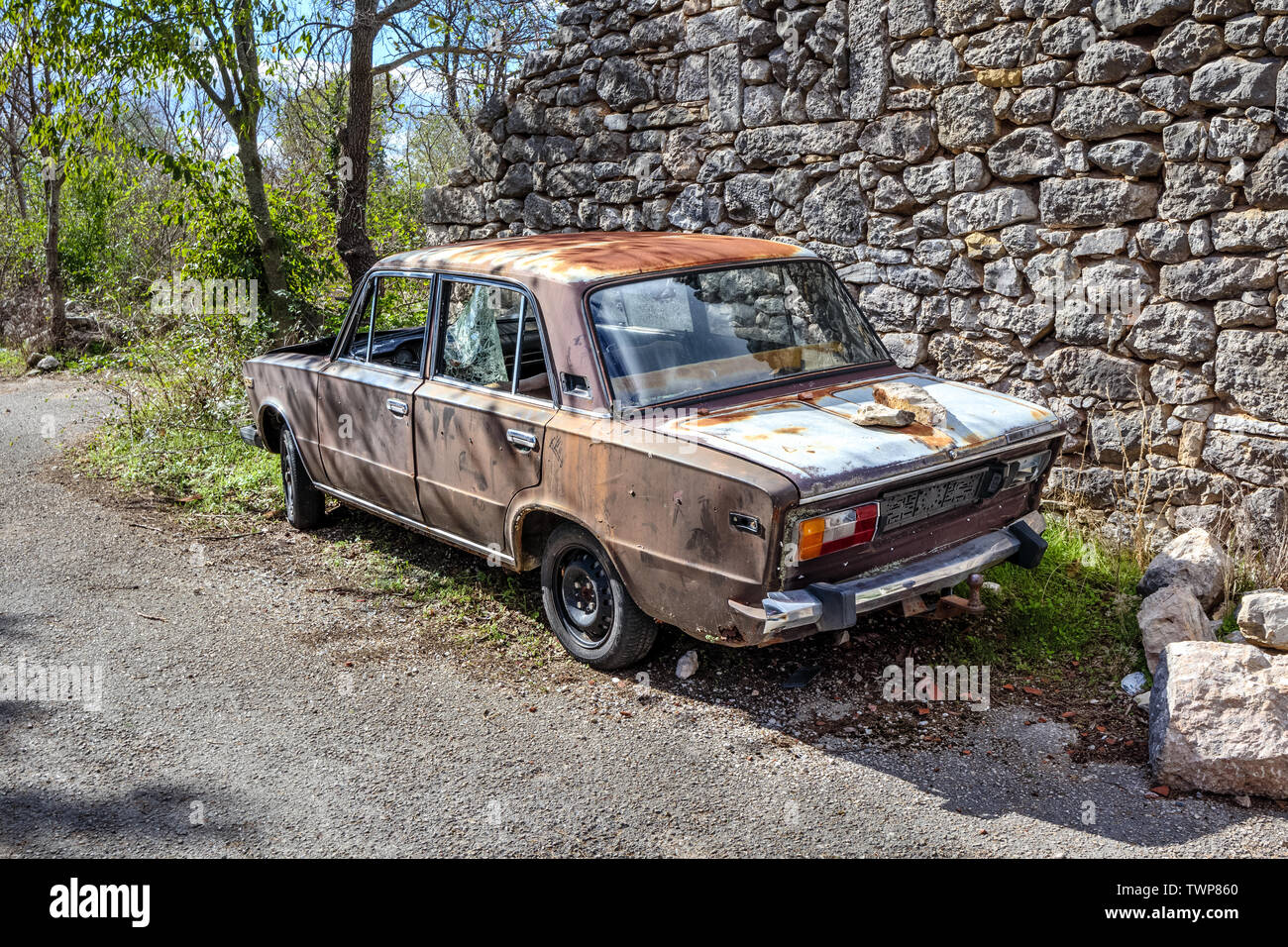 Old rusty car in croatian village Stock Photo - Alamy