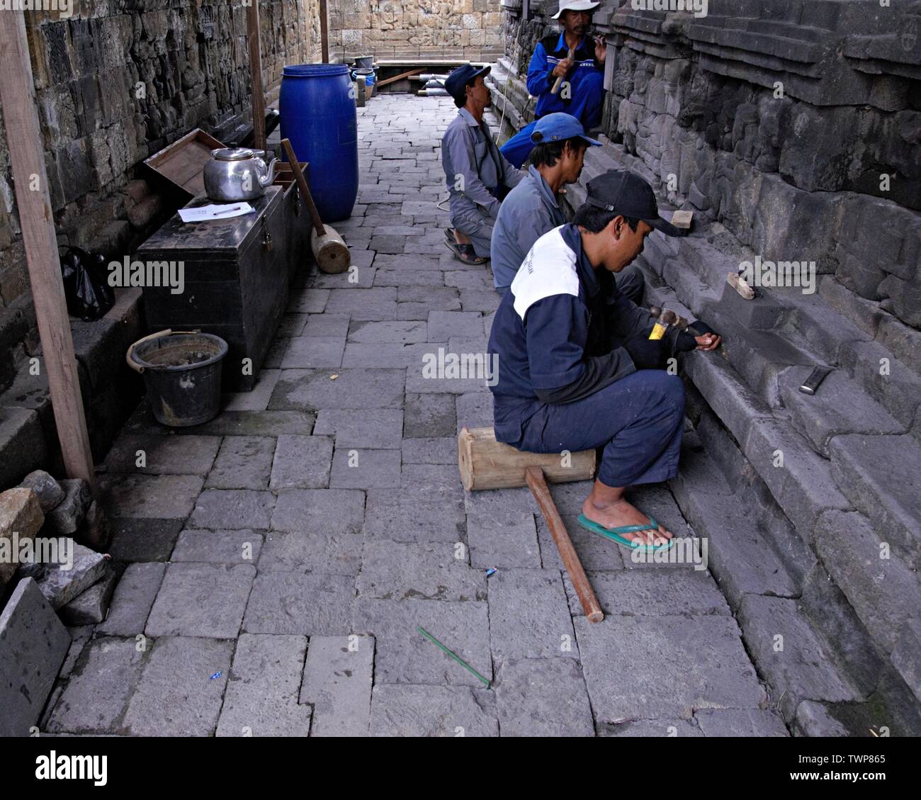 Restoration worker in Borobudur. Borobudur is a 9th-century Mahayana ... Restoration worker in Borobudur. Borobudur is a 9th-century Mahayana ...