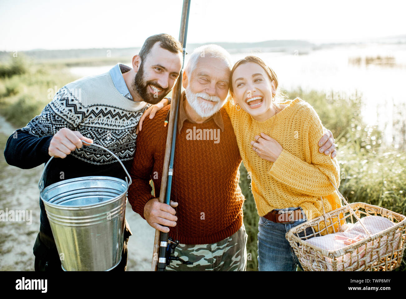 Portrait of a young man and woman with cheerful senior grandfather ...