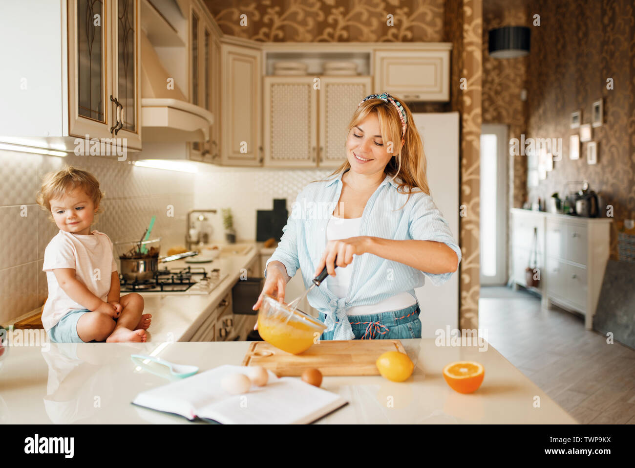Mother and daughter mixing ingredients for cake Stock Photo - Alamy