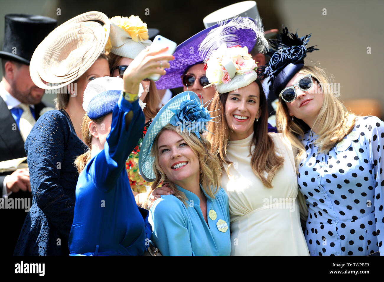 Autumn Phillips (second left) poses for a picture with racegoers during ...