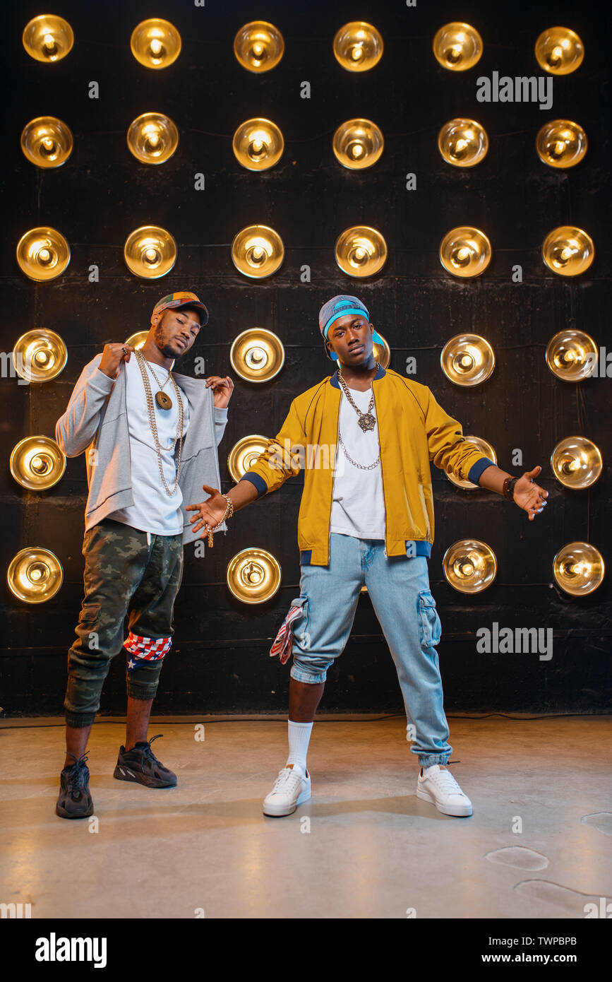 Two black rappers in caps poses on stage Stock Photo - Alamy