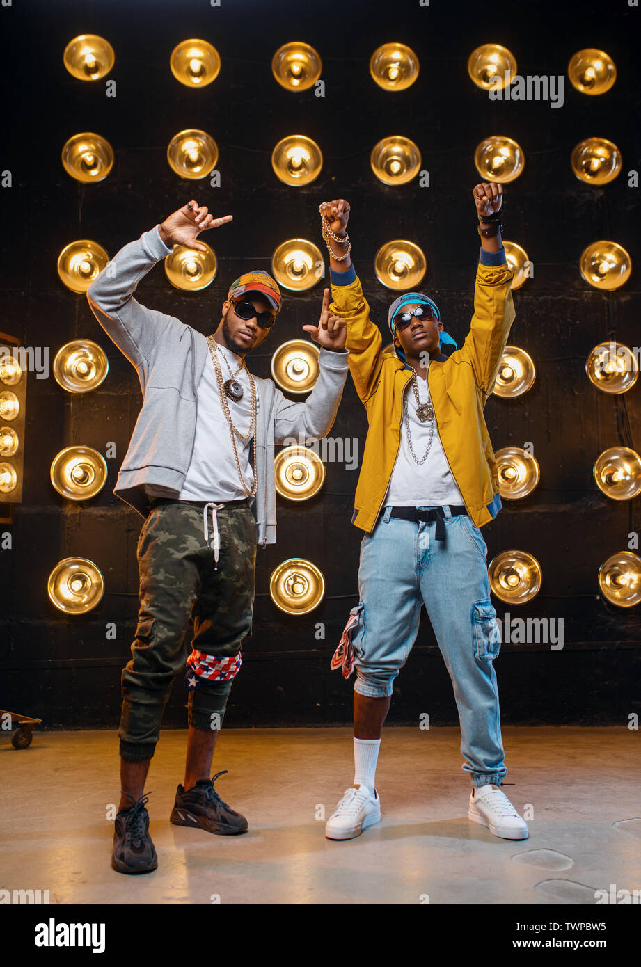 Two black rappers in caps, perfomance on stage Stock Photo - Alamy